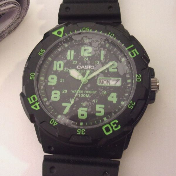 Casio MRW-200H Quartz. Green numbers. Rotating bezel. Store display w ...