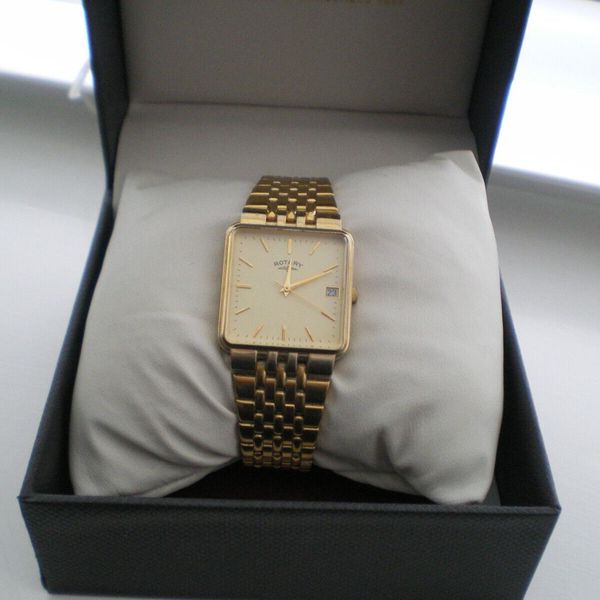mens gold tone rotary watch with date display and its box and some ...